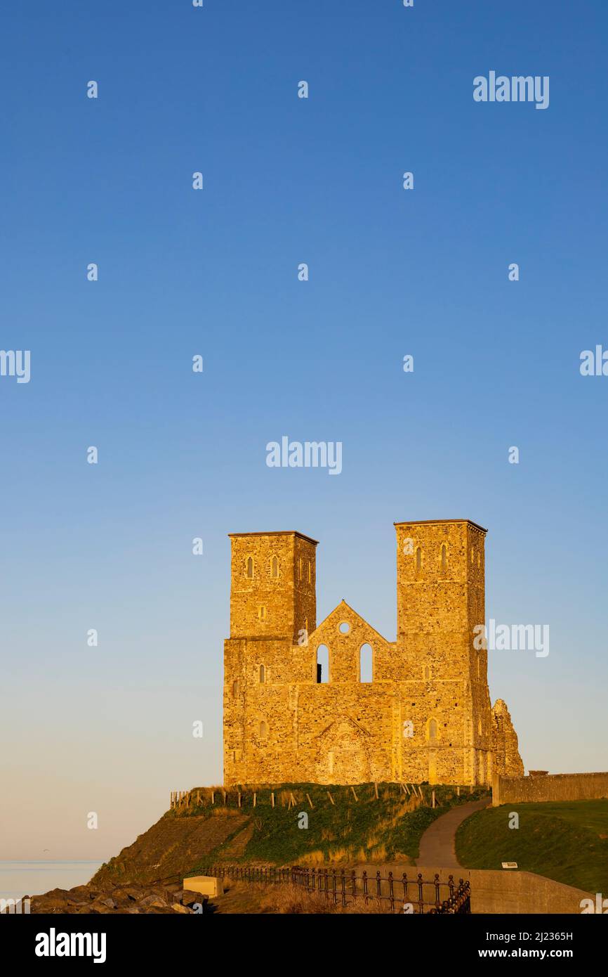 The twin towers of the ruined church of St Mary at Reculver, lit by the ...