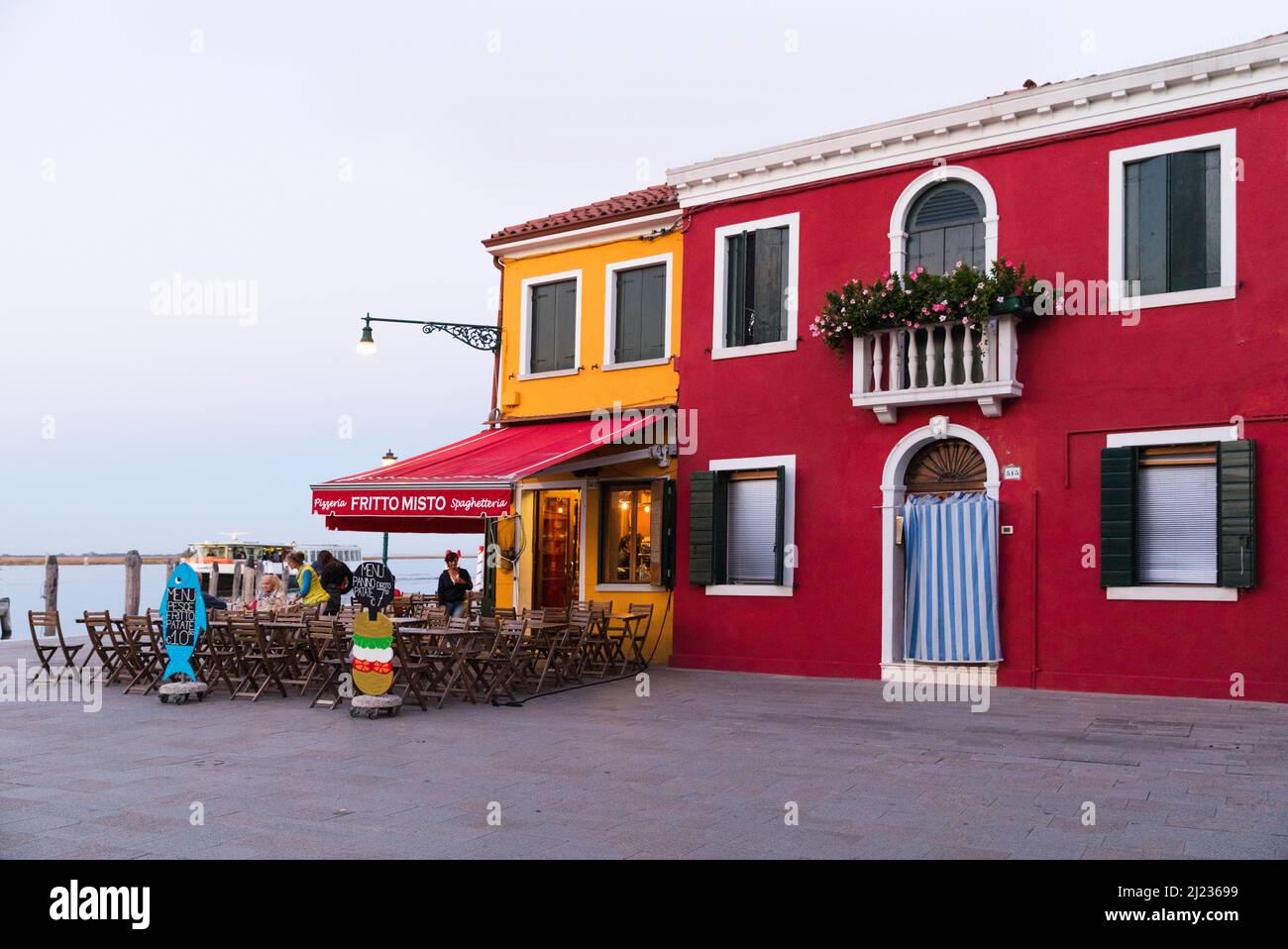 Italy, Venice, Colourful houses cafe on the Venetian island of Burano ...