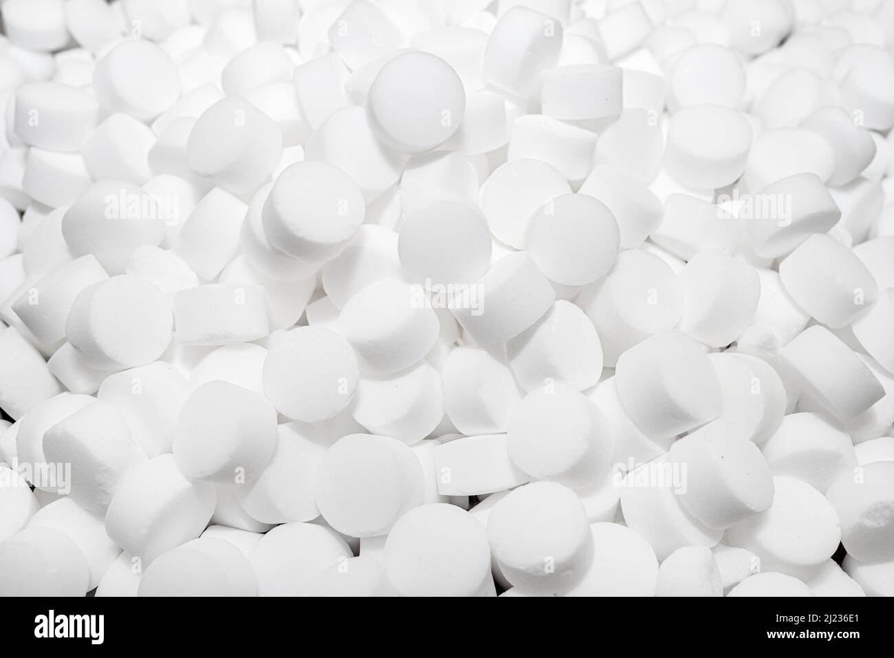 Background made of salt tablets for a water softener, large round cubes ...