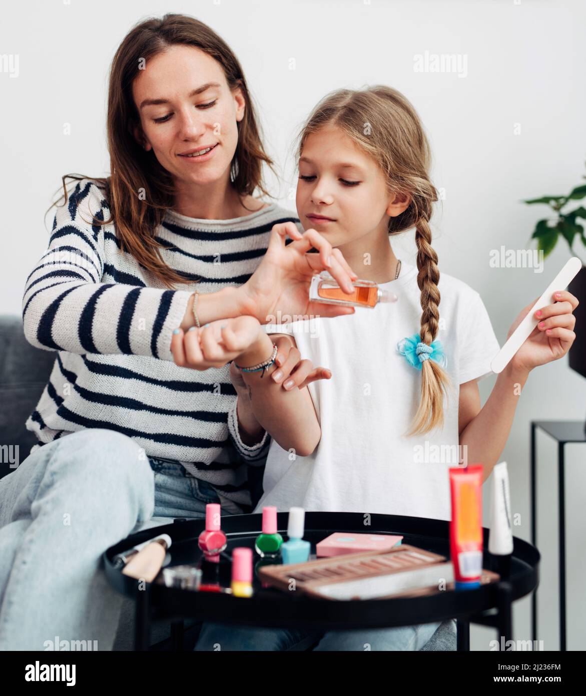Mother and daughter wearing perfume Stock Photo - Alamy