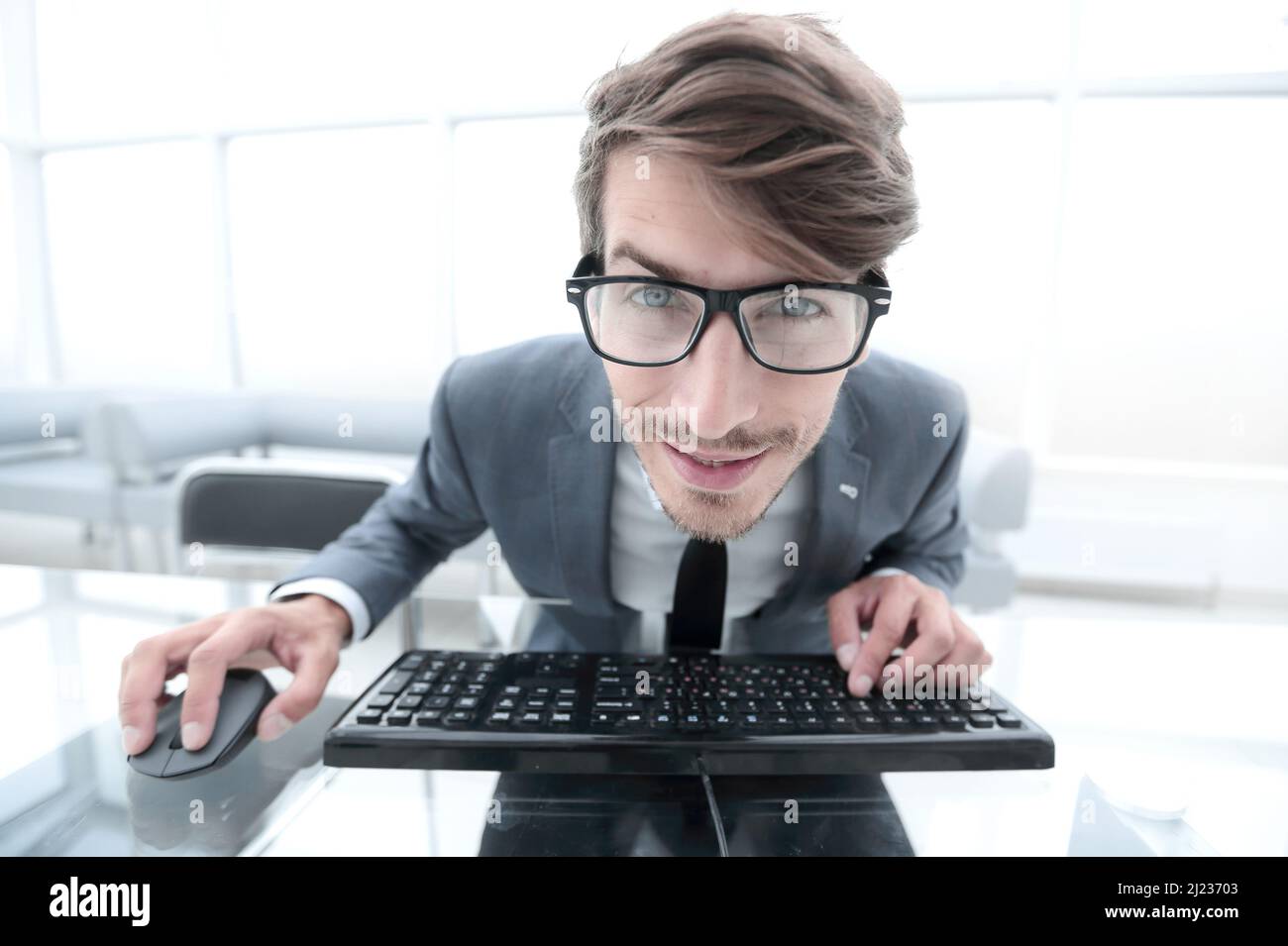 Crazy looking man typing on the keyboard Stock Photo - Alamy