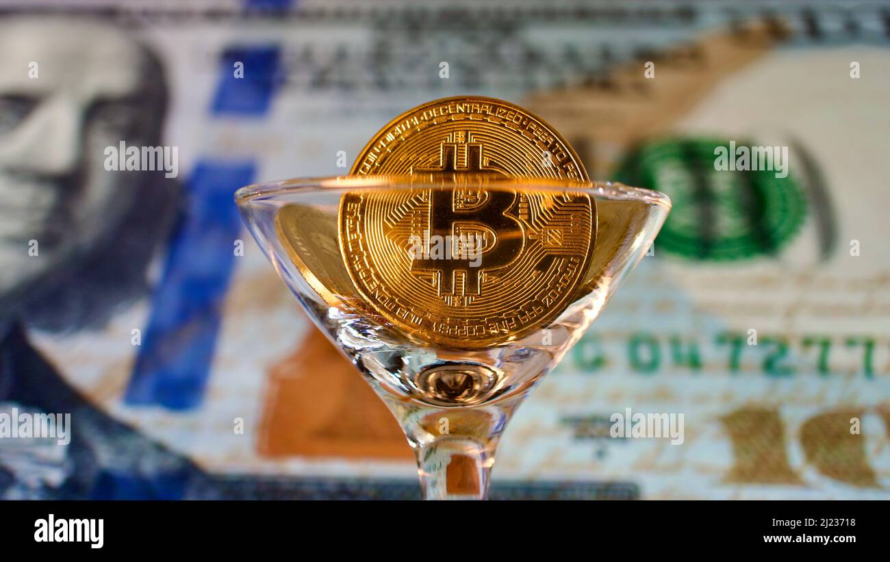 Paper banknotes USD Dollar, gold crypto currency bitcoin in front of ...