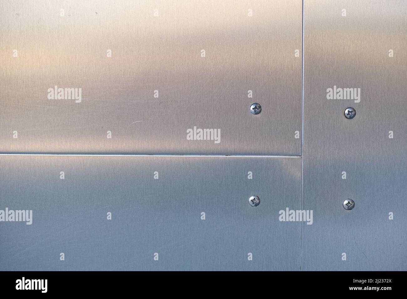 Brushed sheet metal. Shiny sheet metal attached with bolts Stock Photo ...