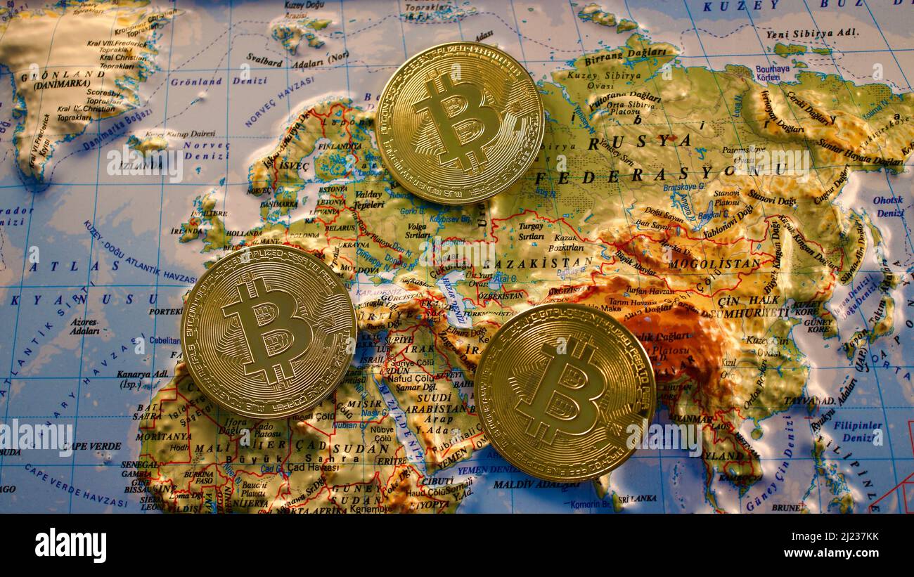 Gold metal bitcoin coins on a 3D relief world map Stock Photo - Alamy