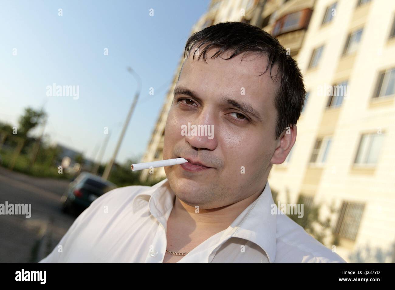 The man with a cigarette poses outdoor Stock Photo - Alamy