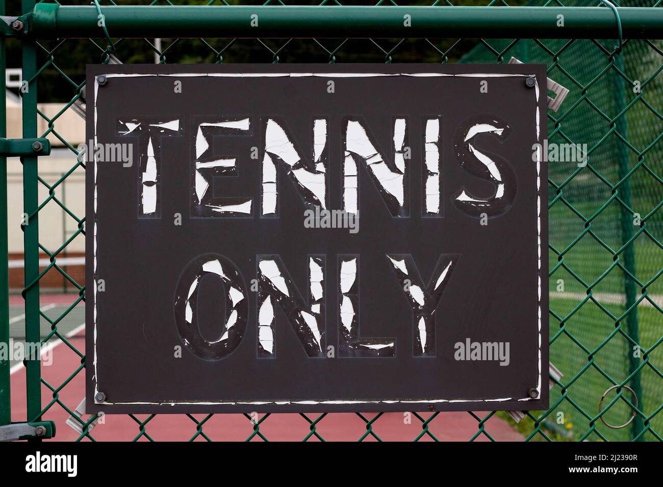 Old metal sign that says Tennis Only in black and white hanging on a ...