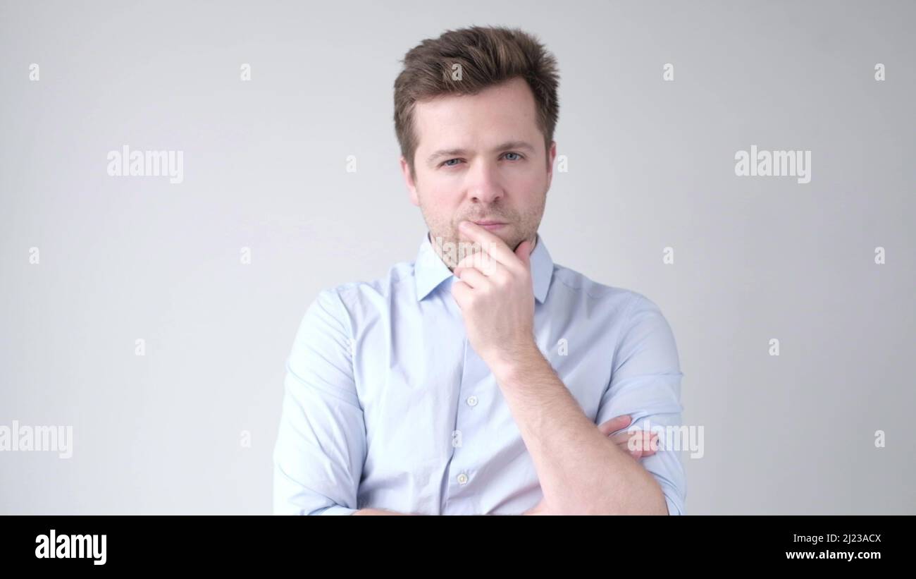 Pensive young man trying to make a right decision in complicated life ...