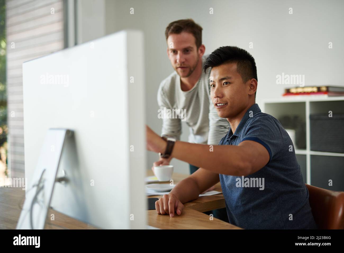 Sharing his ideas. Cropped shot of two designers working together on a ...