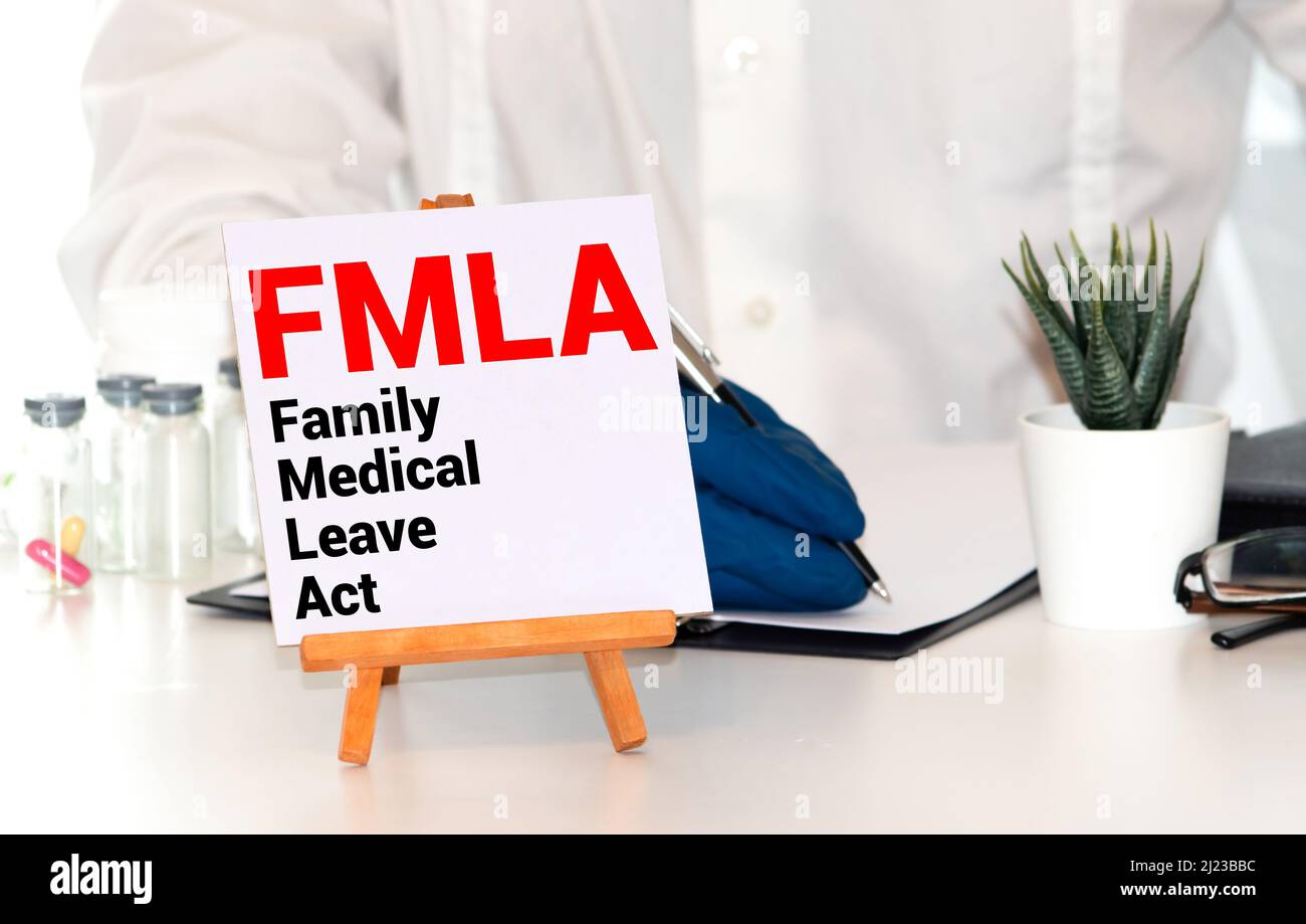 Family And Medical Leave Act FMLA written on notebook with stethoscope, syringe and pills ...