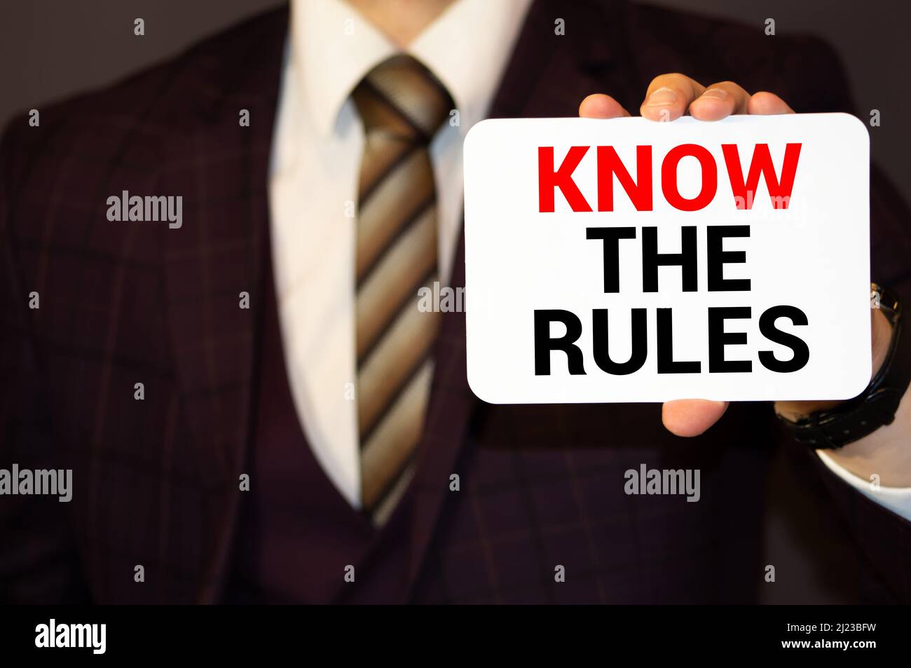 KNOW THE RULES, message on the card shown by a man Stock Photo - Alamy