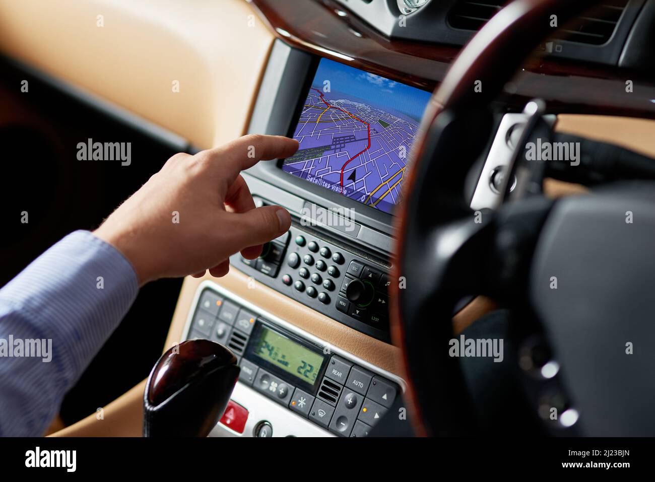 Let technology lead the way. Closeup shot of a driver using a cars GPS ...