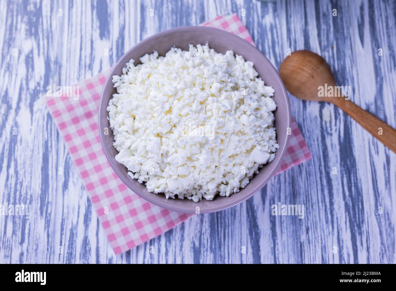 dairy product cottage cheese in a plate on a wooden background Stock ...