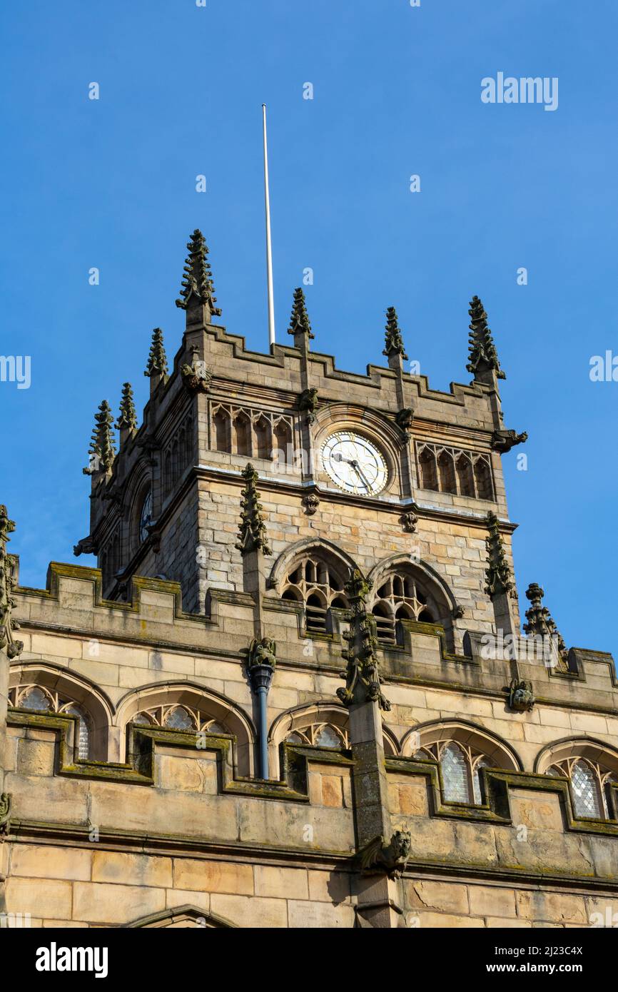 All Saints' Church, also known as Wigan Parish Church, with blue sky's ...