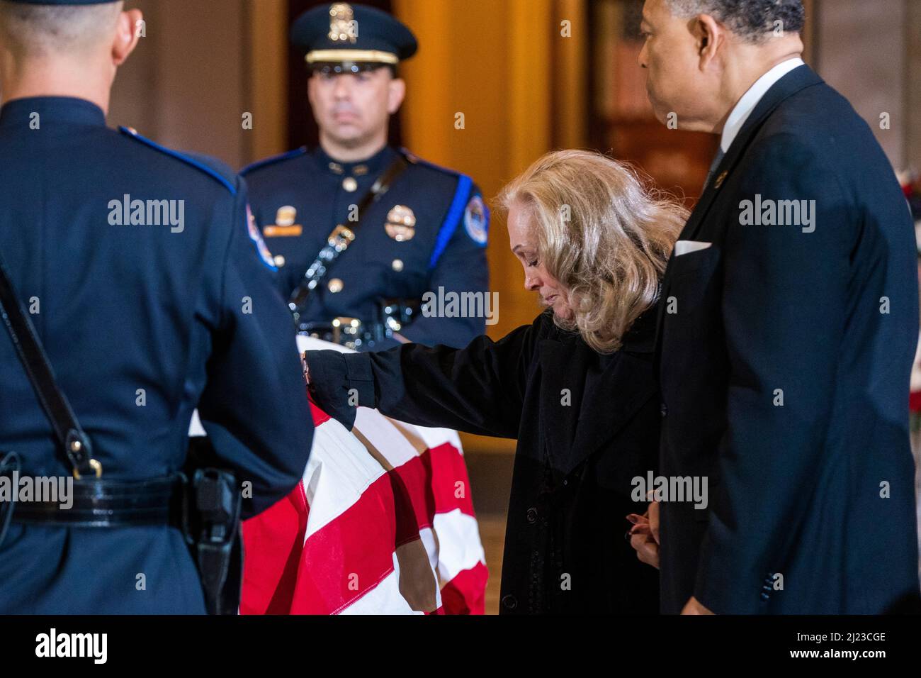 Washington, USA. 29th Mar, 2022. Anne Walton pauses at the casket of ...