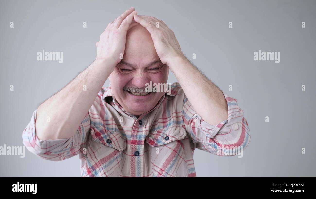 Upset, stressed out senior sick, tired man after bad day at work ...