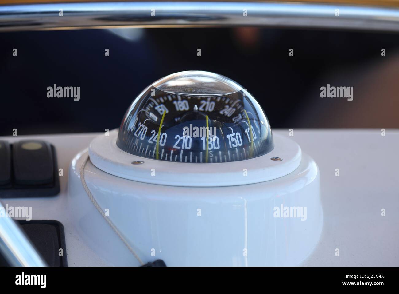 A big compass on a boat showing direction. Harbor background Stock ...