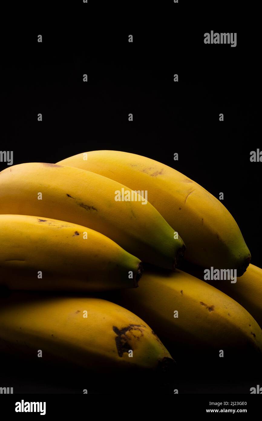 Macro photography of some bananas on a black background Stock Photo - Alamy