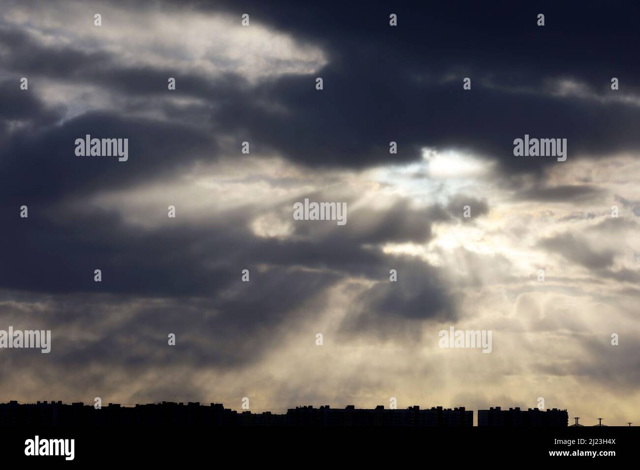 Storm sky over the city buildings covered with dark cumulus clouds ...