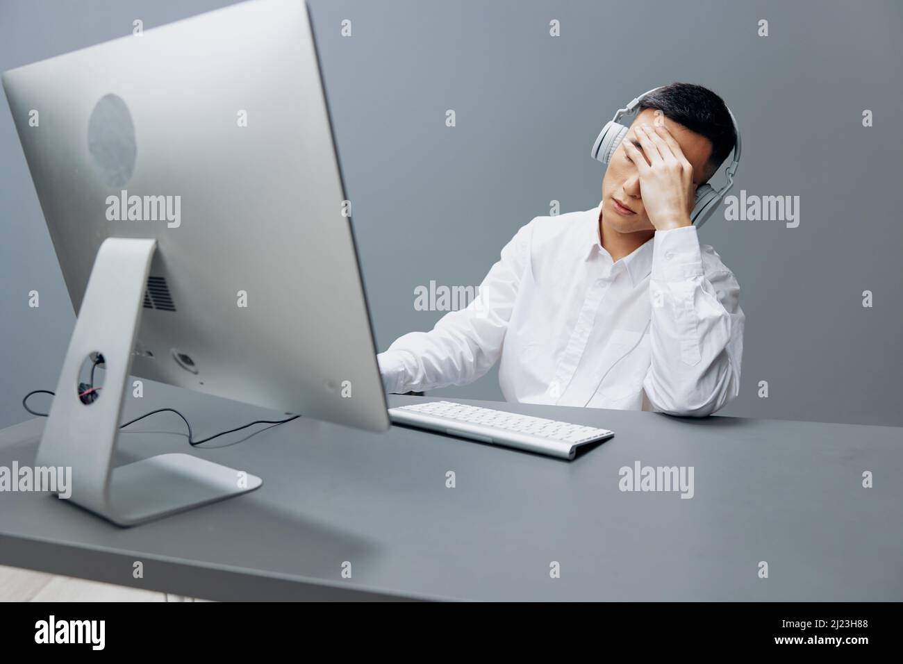 businessmen in front of the computer with headphones emotions isolated ...
