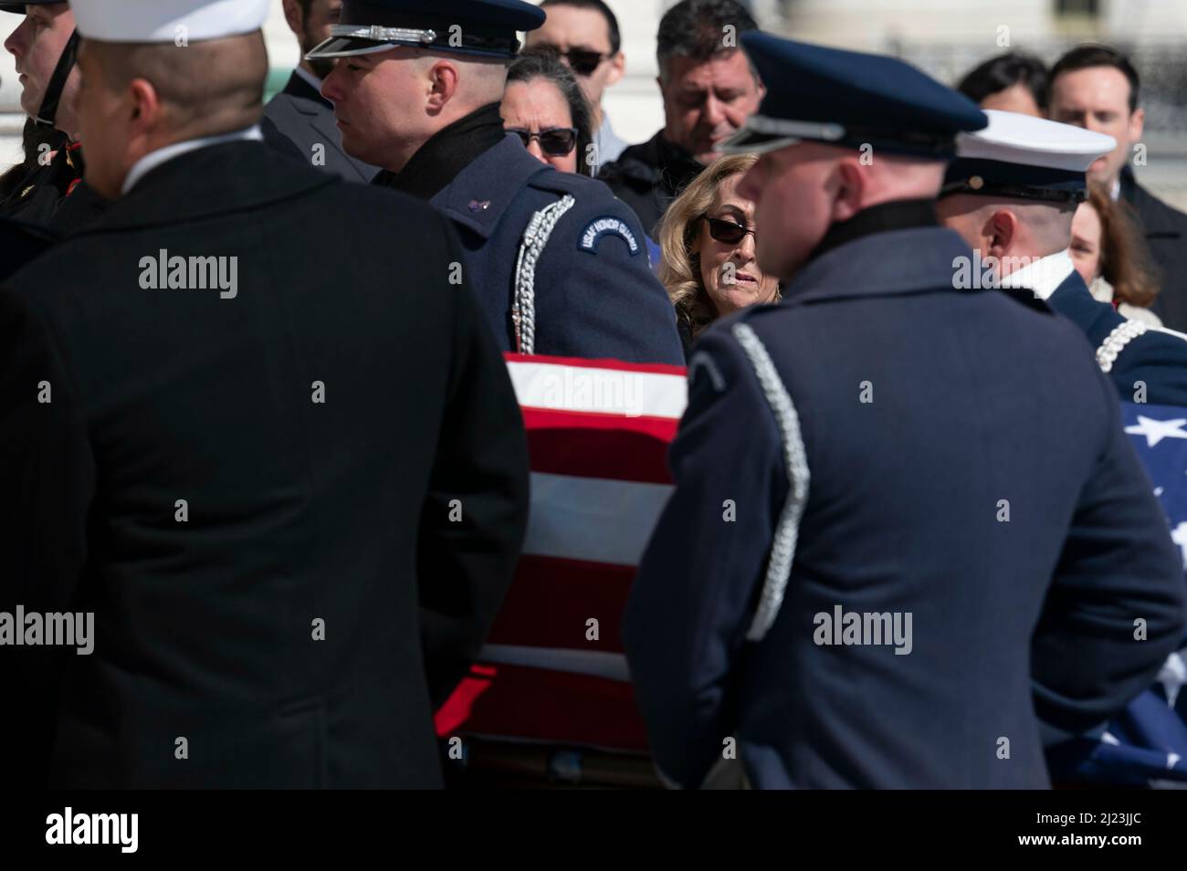 Anne Young (C), the wife of Congressman Edwin Young, watches as an ...