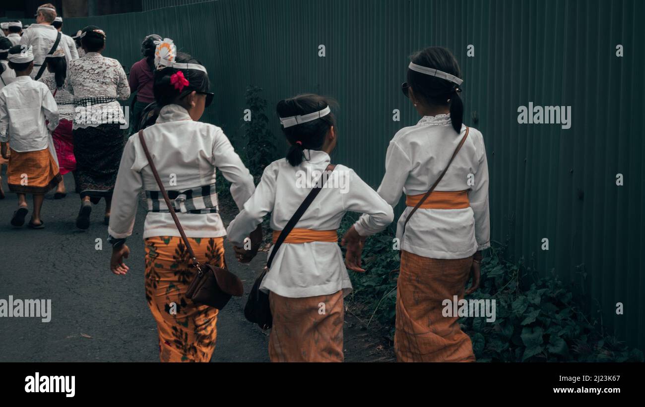 A back shot of group of local girls wearing traditional costumes and ...