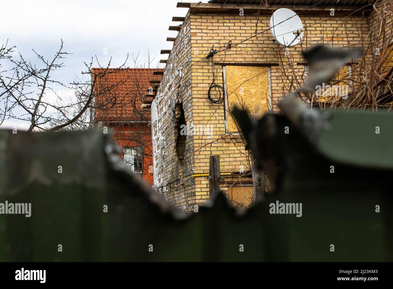 Boyarka, Ukraine. 29th Mar, 2022. A home and a fence damaged by a ...