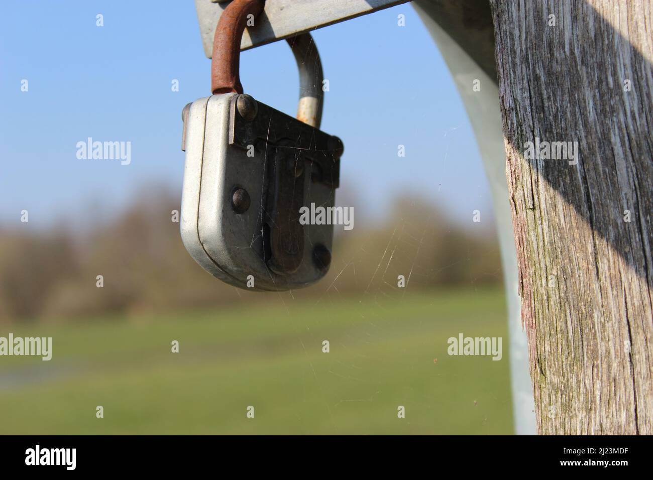 A closeup shot of a lock on the wooden fence Stock Photo - Alamy