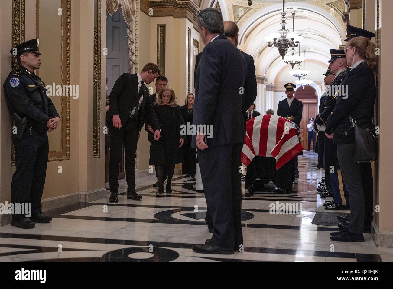 Widow Anne Young (3rd L) is escorted past her husband’s casket during ...