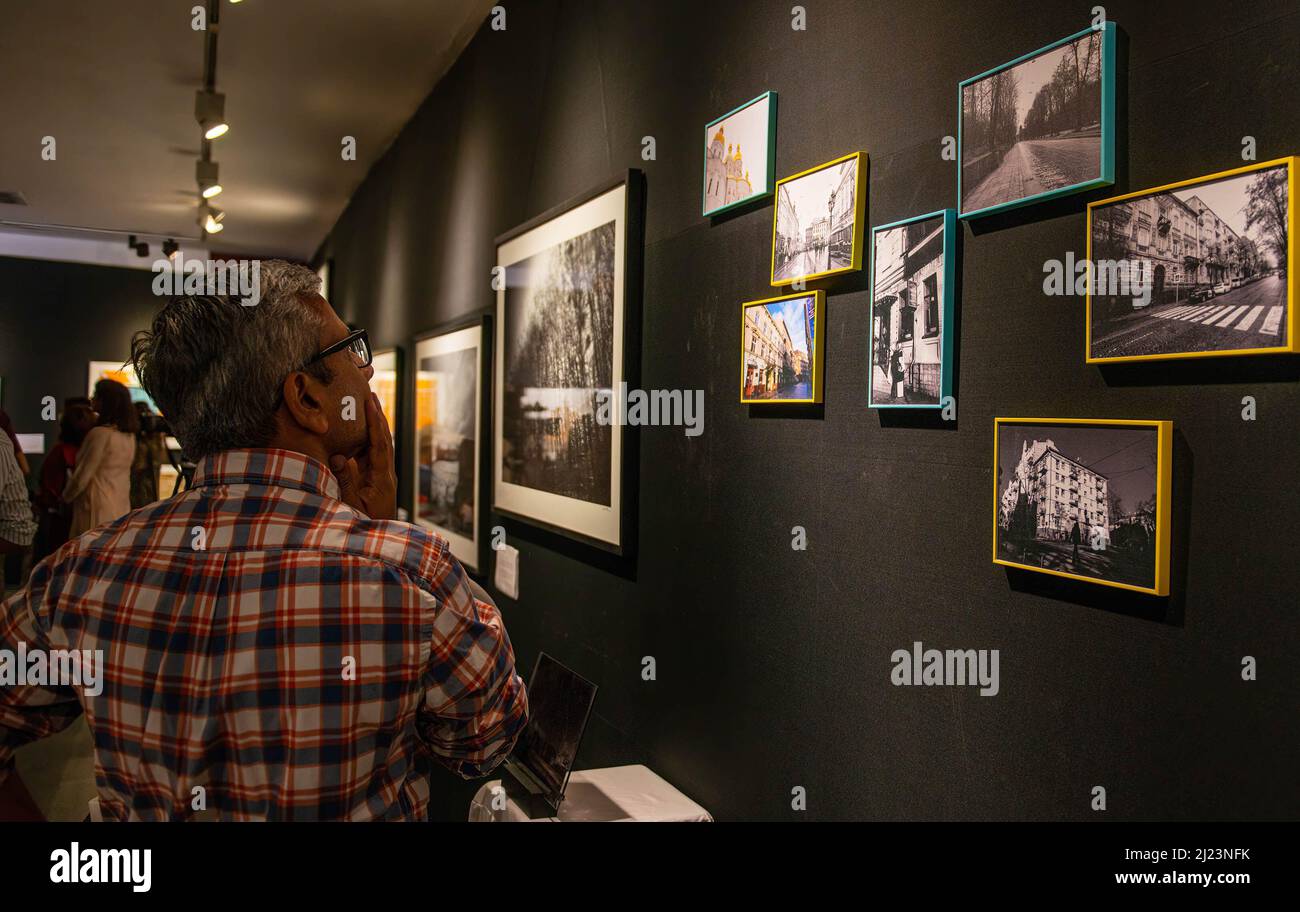 New Delhi, India. 29th Mar, 2022. A visitor looks at a wall of framed ...