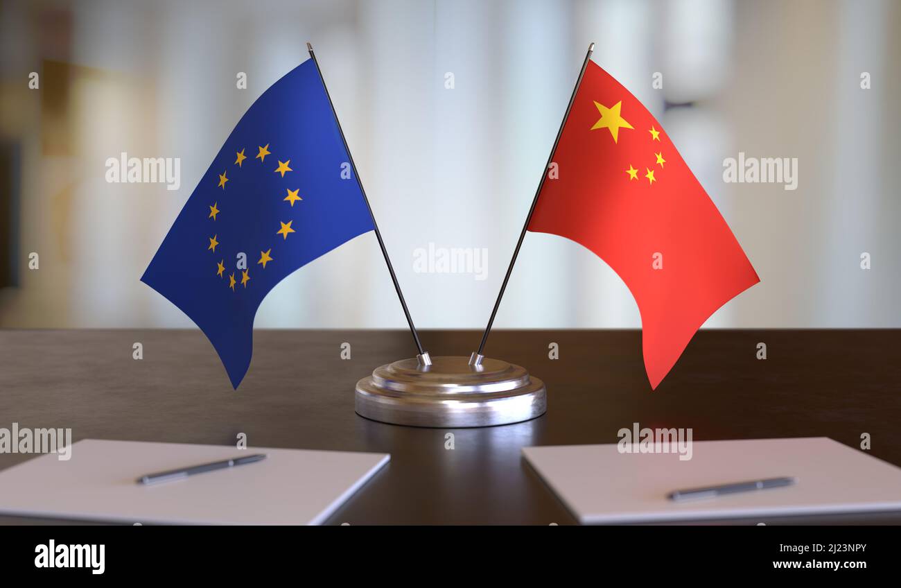 Chinese and EU flags on table. Negotiation between European Union and ...