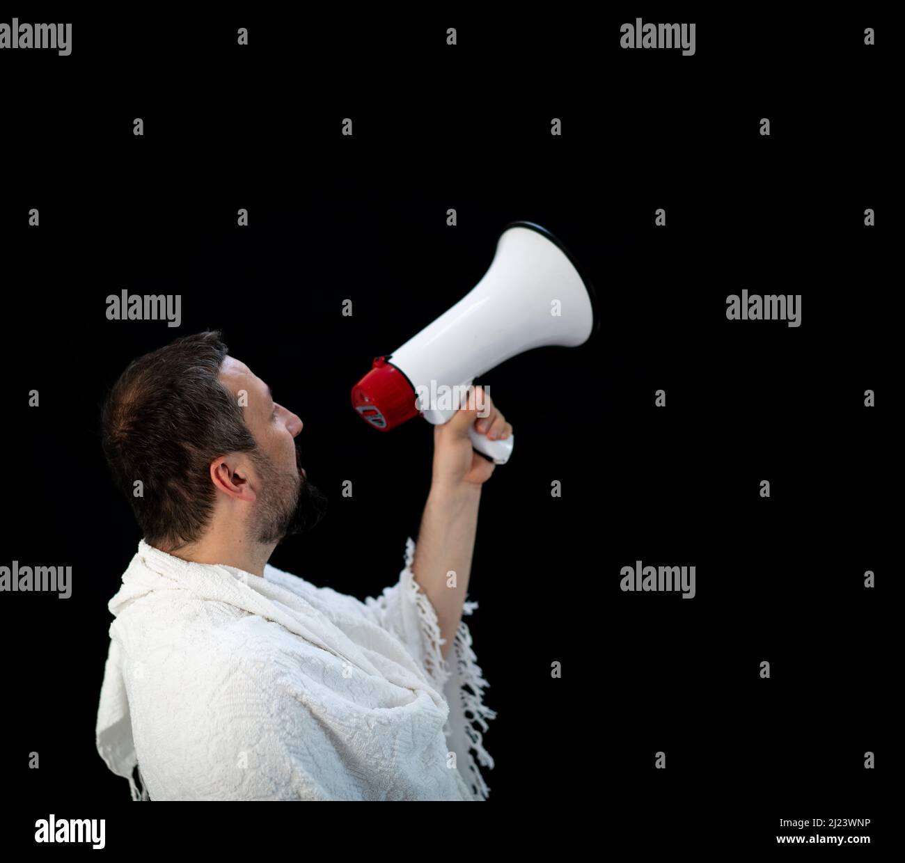 Muslim pilgrim in white traditional clothes, saying message on ...