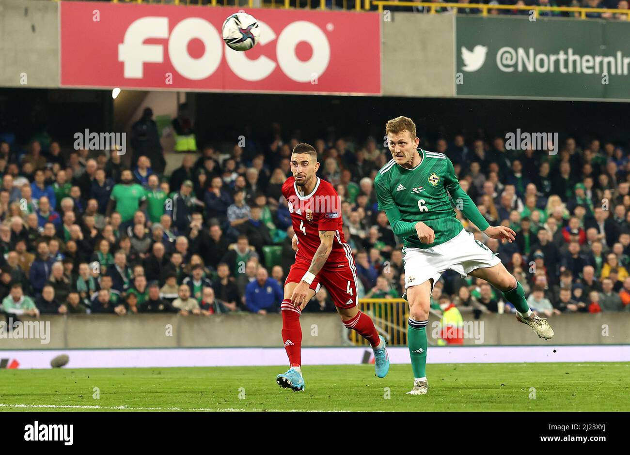 Northern Ireland's George Saville (right) heads towards goal during the ...