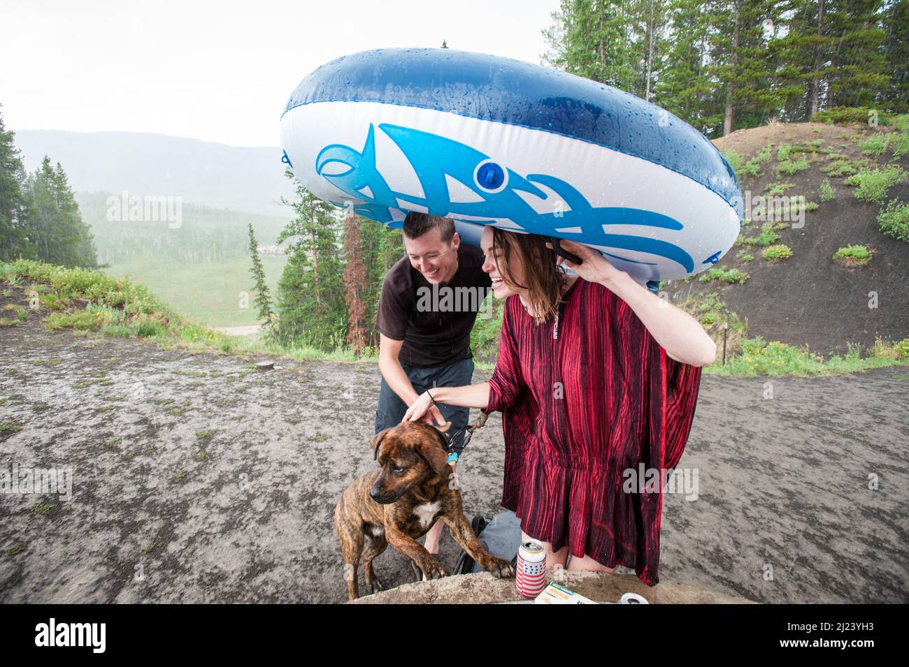 Young couple going for a swim with their dog a lake Stock Photo - Alamy