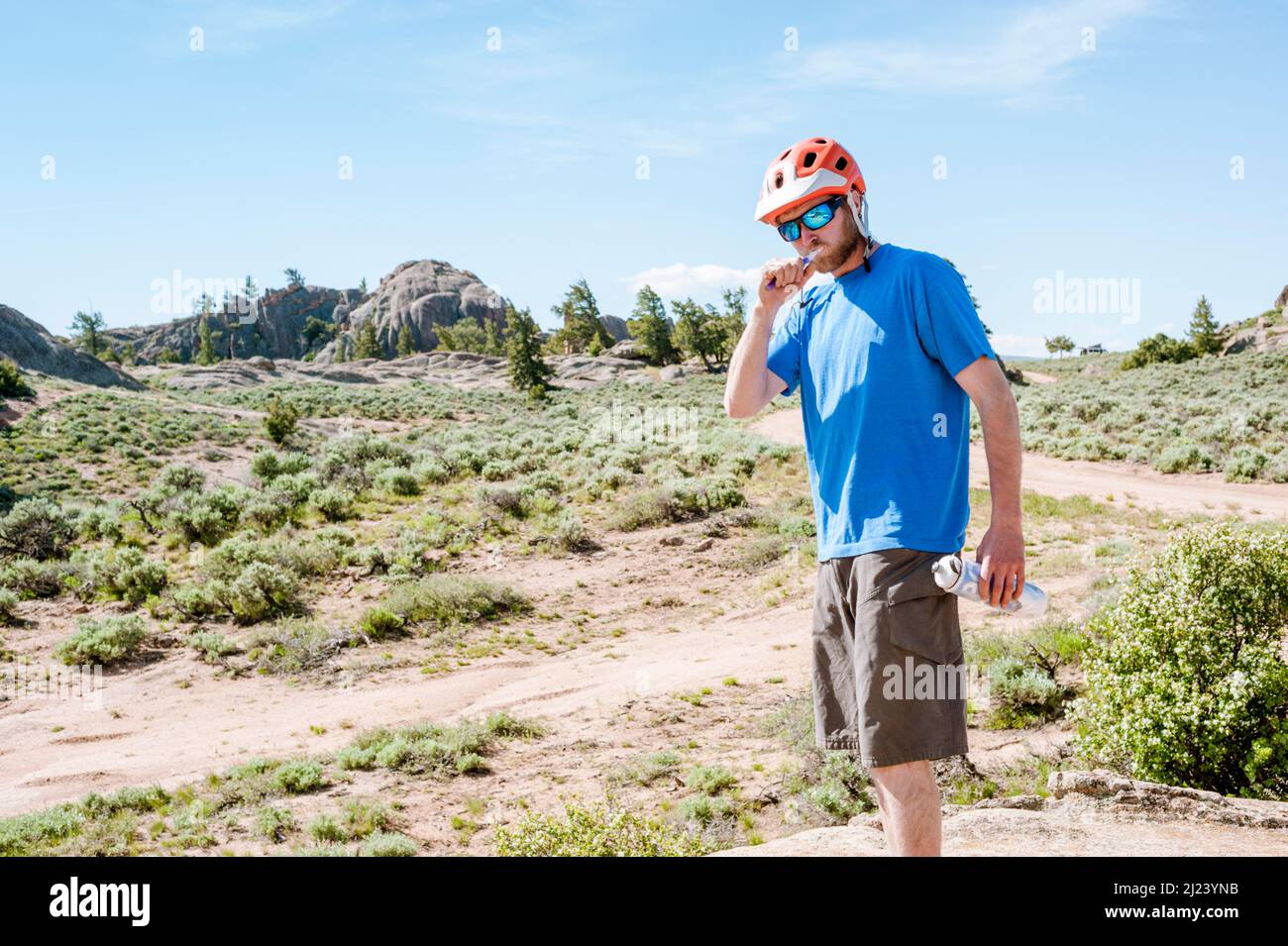 A young man brushing his teeth before a mountain bike ride Stock Photo ...
