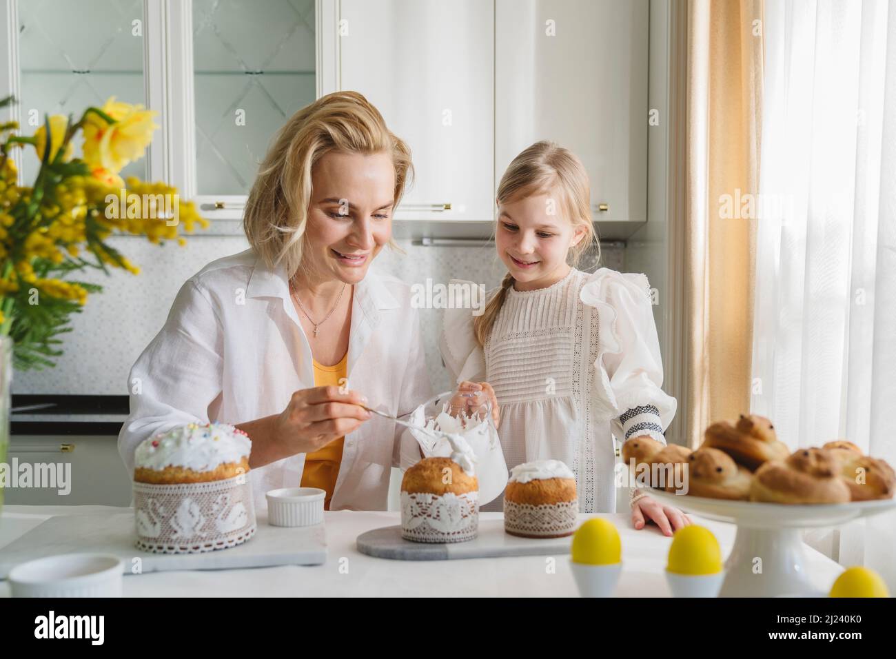 Mom and daughter cook together in the kitchen Stock Photo - Alamy