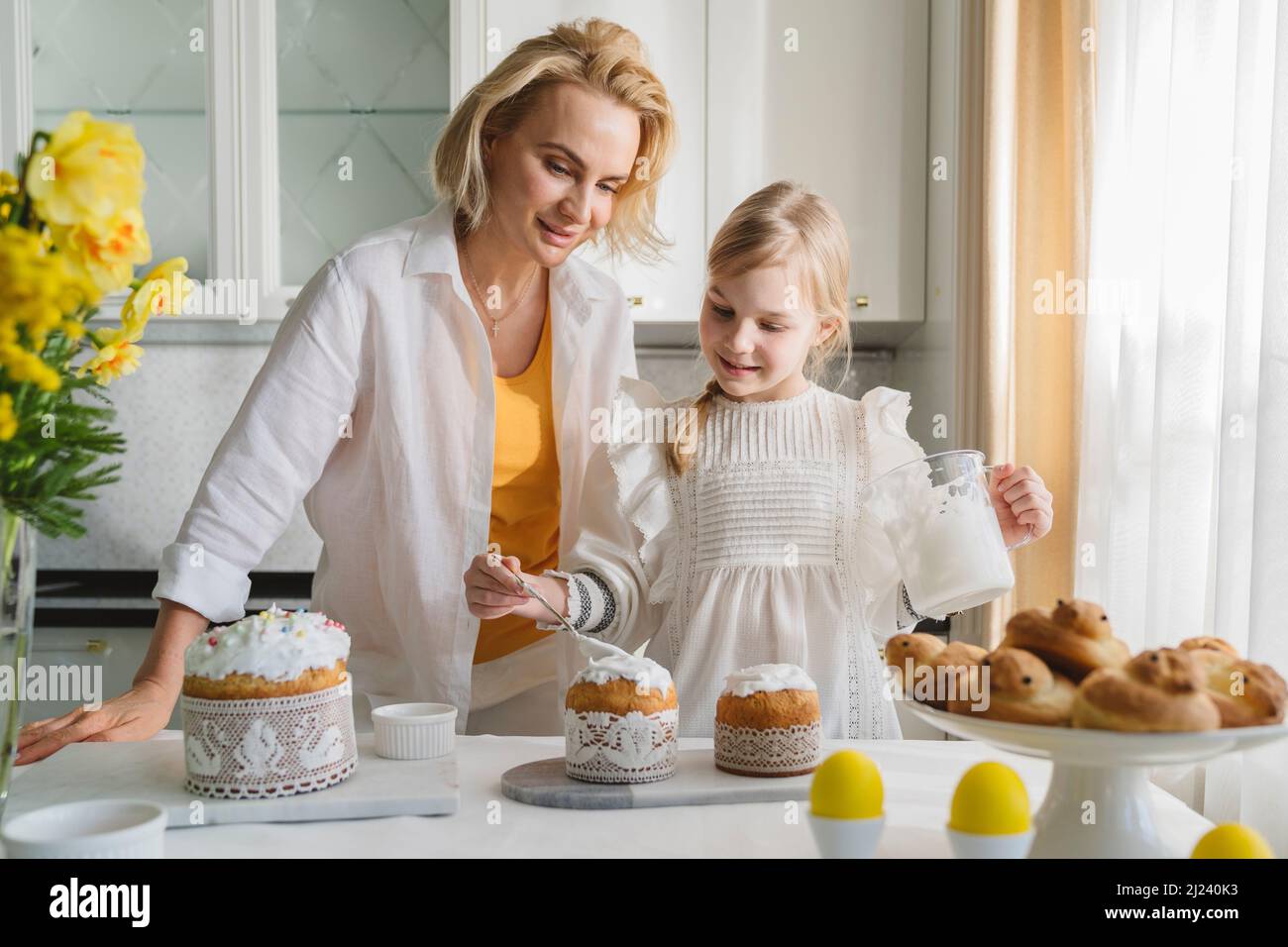 Mom and daughter cook together in the kitchen Stock Photo - Alamy