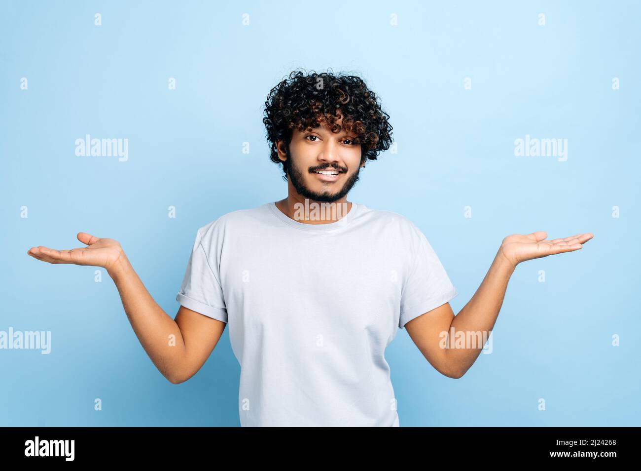 Puzzled Confused Indian Or Arabian Curly Haired Man In Casual Wear