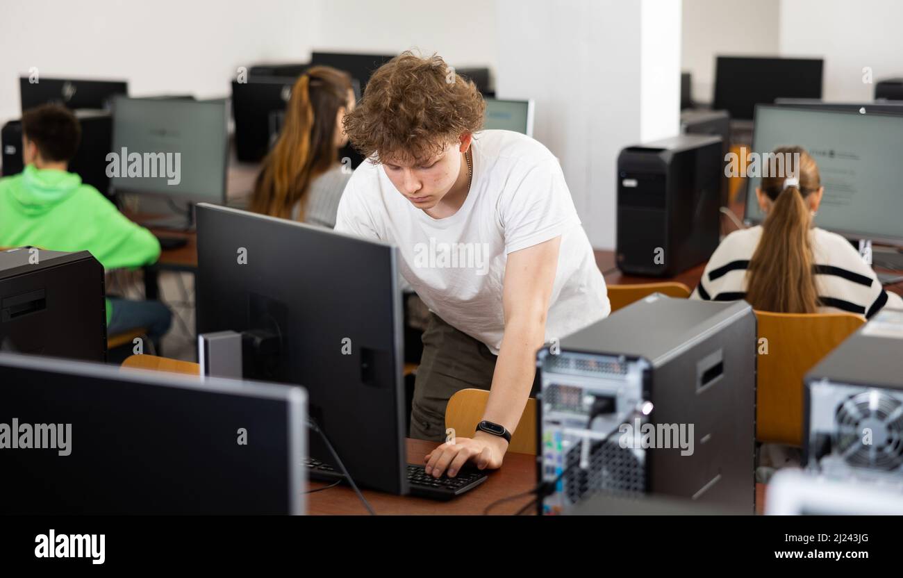 Portrait of guy working at computer in computer class at school Stock ...