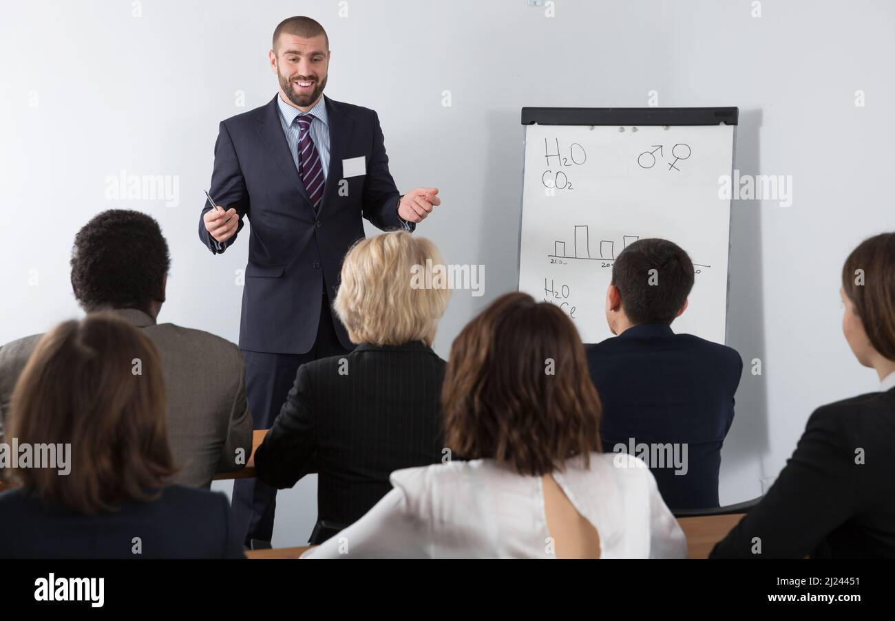 man giving presentation to colleagues at international business meeting ...