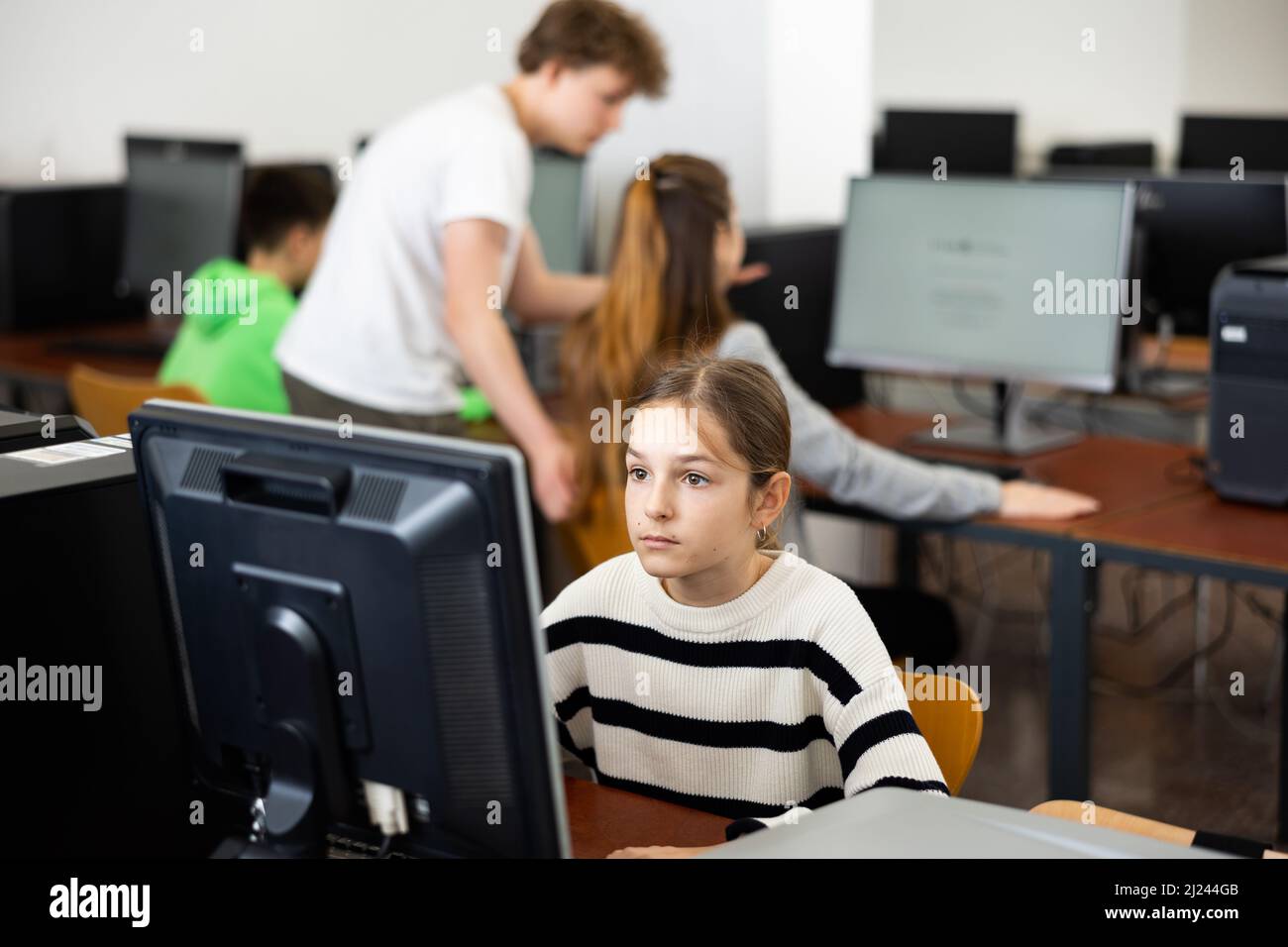 Schoolgirl using PC during computer science lesson Stock Photo - Alamy