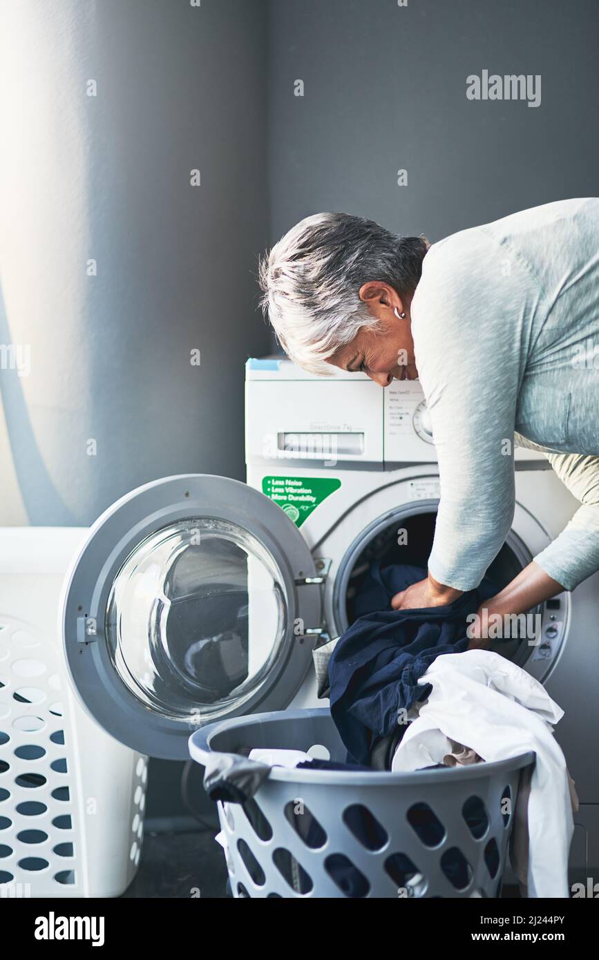 Lets get down to laundering business. Shot of a mature woman doing ...