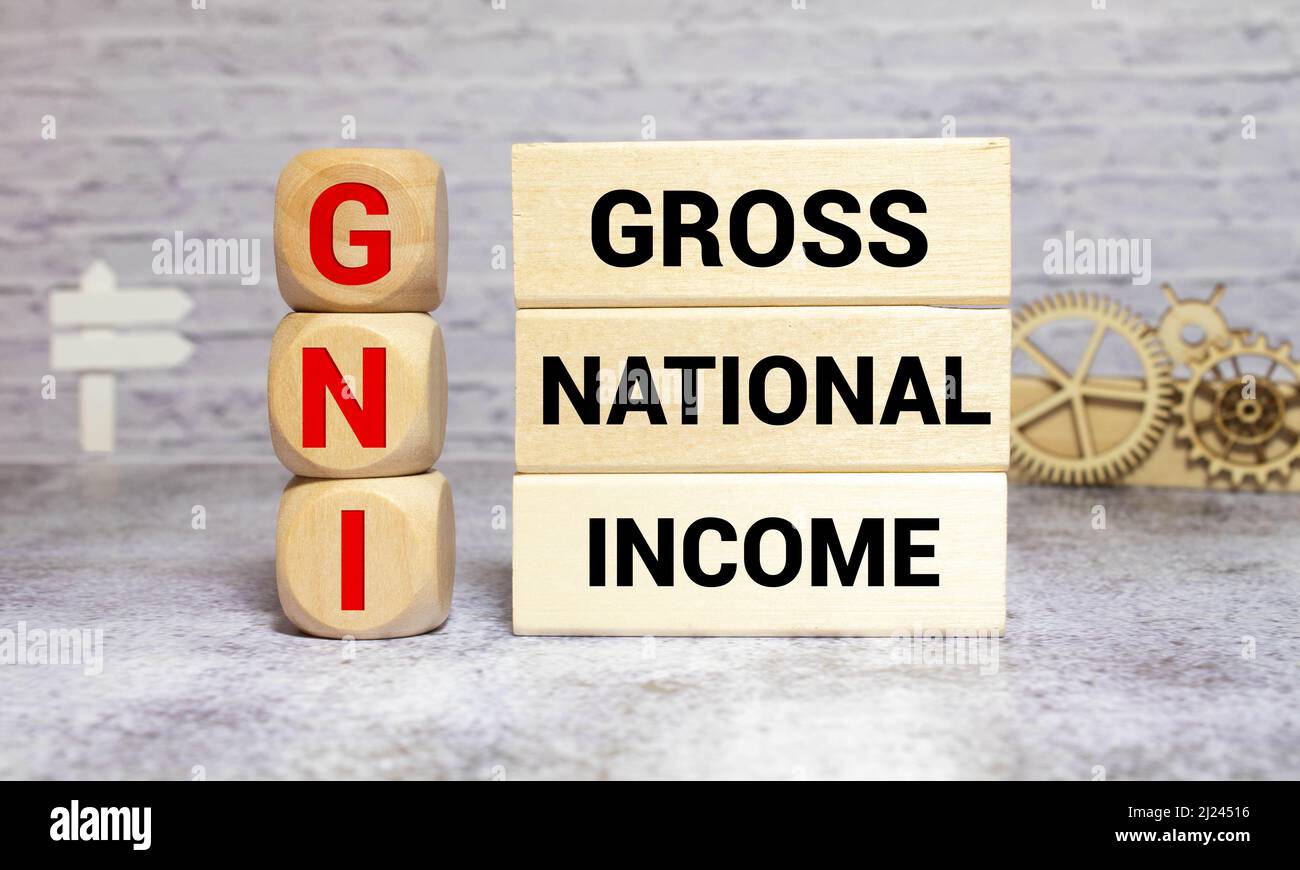 Wooden blocks with the word Gni and up arrow. Gross national income is ...