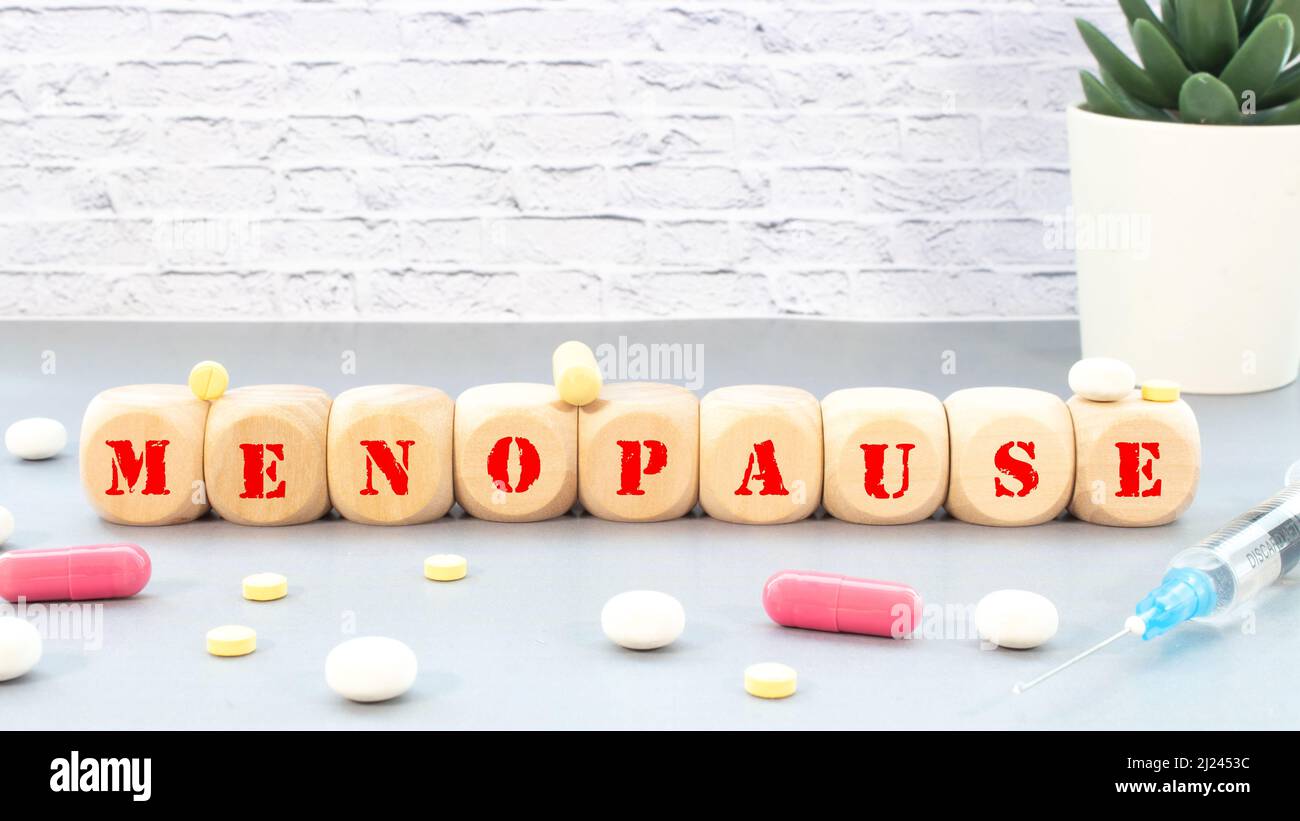 menopause word written on wood block. menopause text on table, concept ...