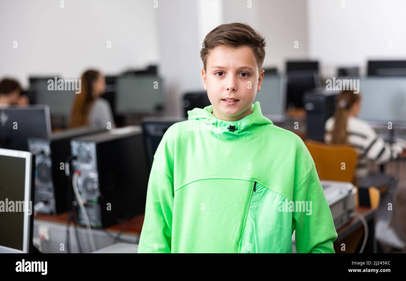 Tween schoolboy standing in computer class ready for lesson Stock Photo ...