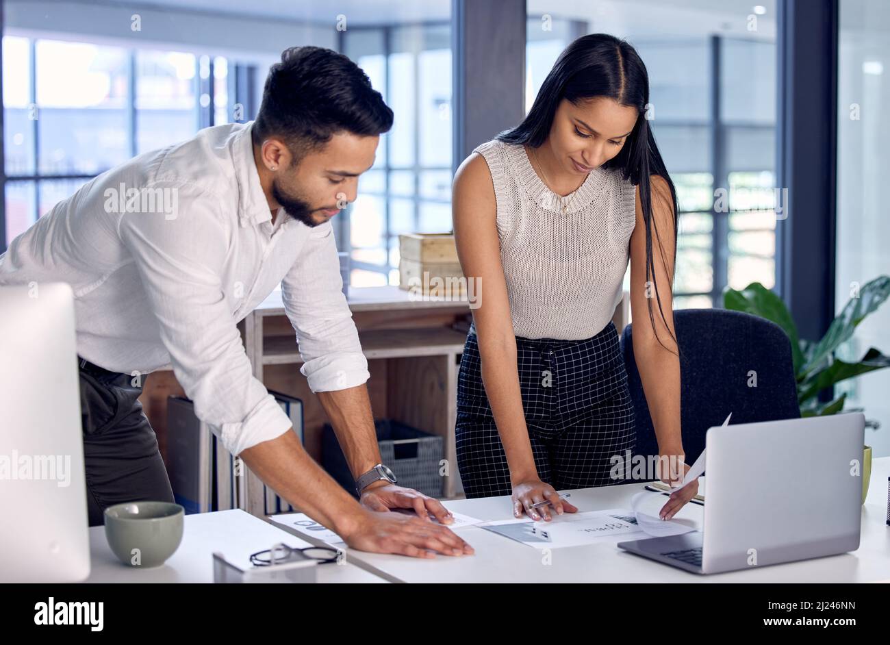 Will you approve these documents please. Shot of two work colleagues ...