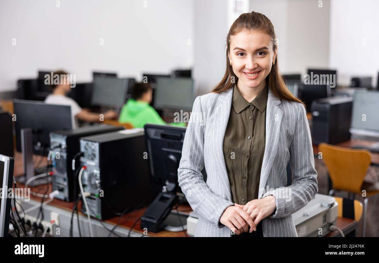 Portrait of young smiling female computer class teacher at school Stock ...