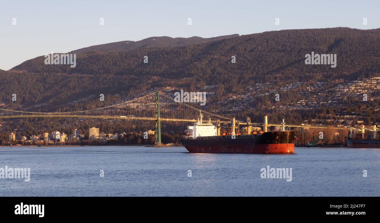 Container Ship arriving to Vancouver Harbour, mountains and Lions Gate ...