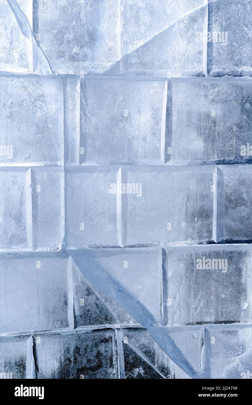Large blocks of translucent ice outdoors in winter forming an ice wall ...
