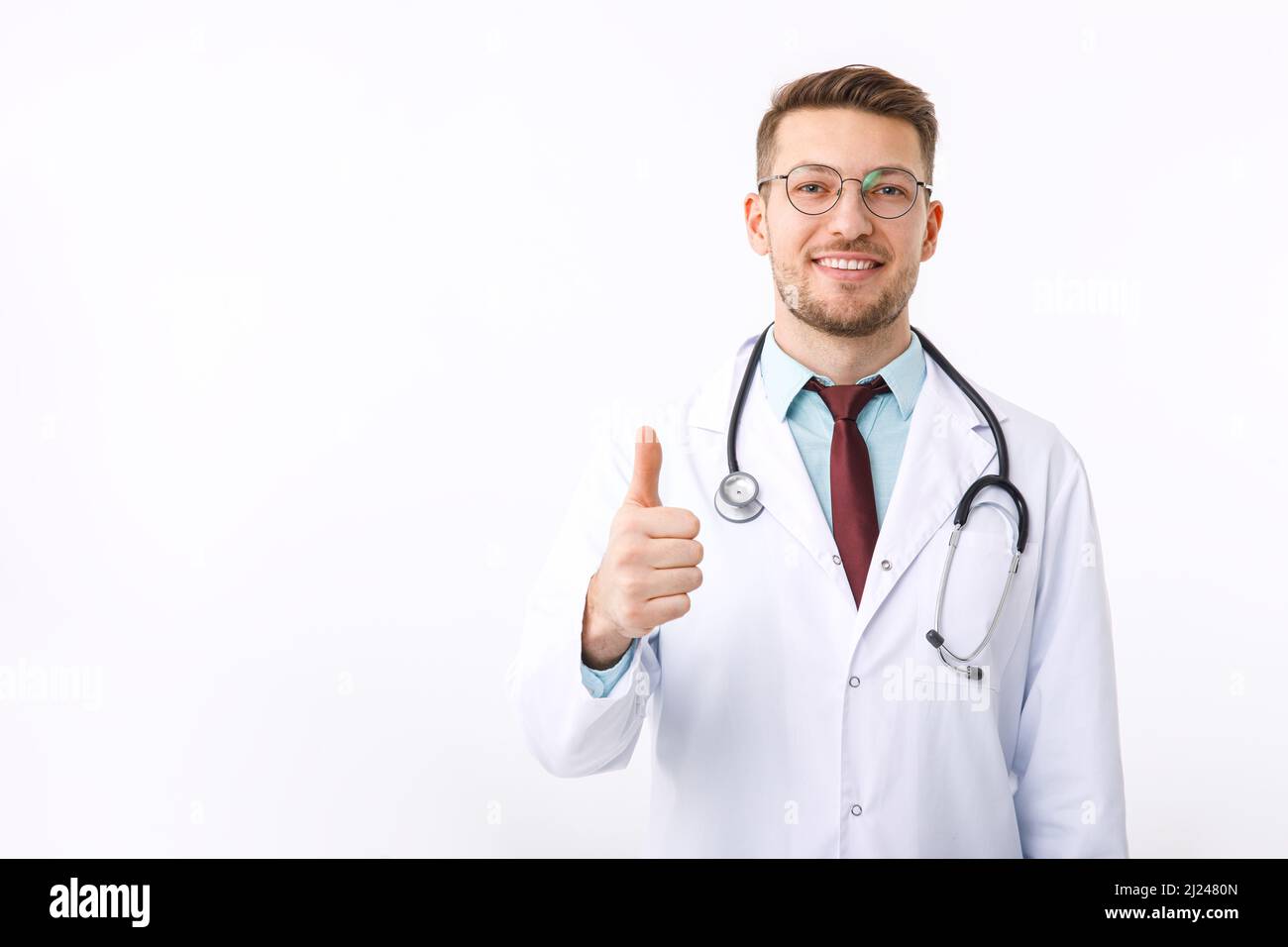 Portrait of confident young medical doctor on white background. The ...