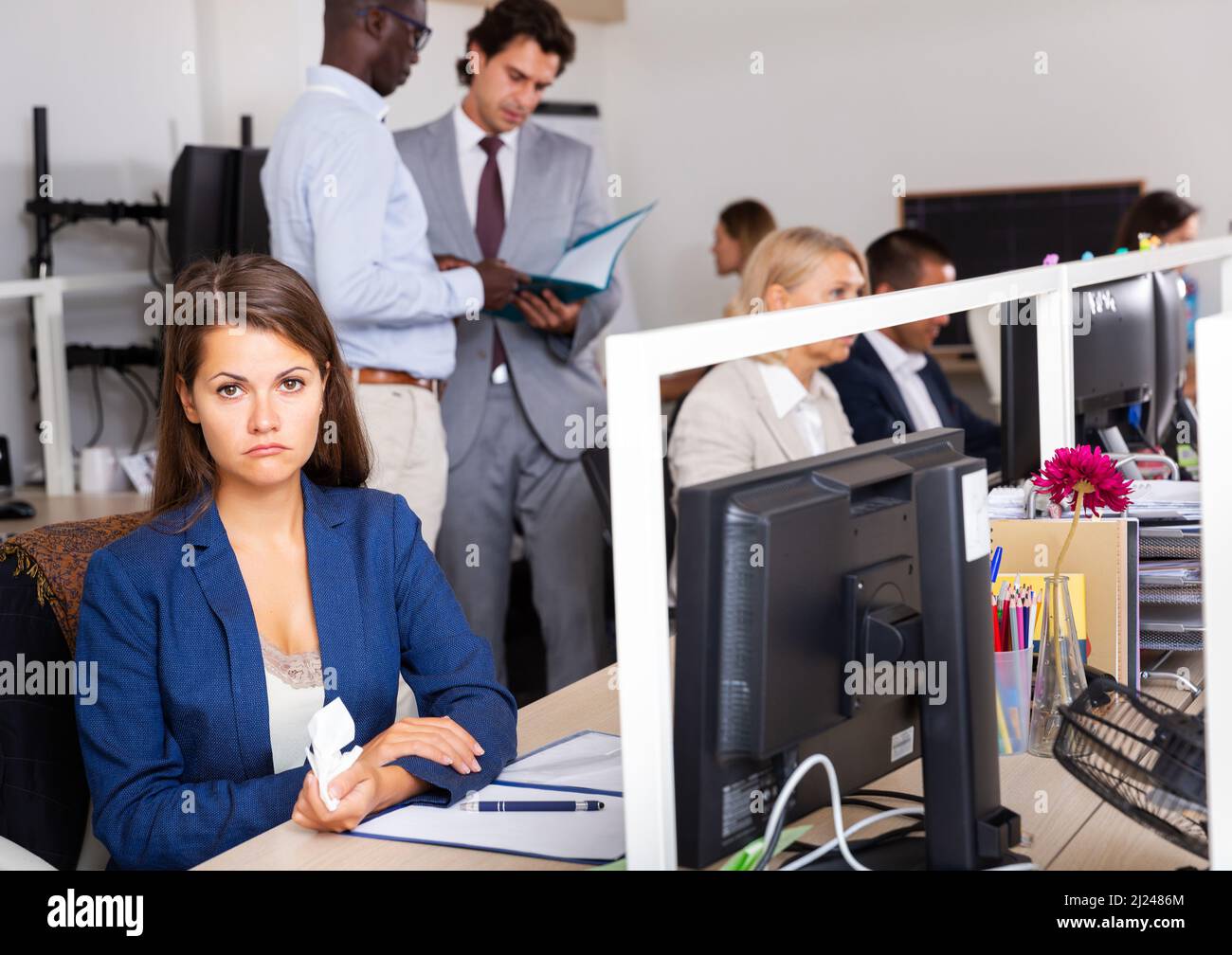 upset girl sitting at desk in modern open plan office Stock Photo - Alamy